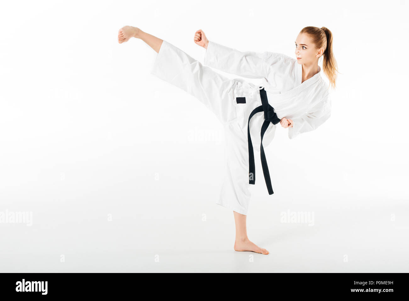 female karate fighter training kick isolated on white Stock Photo - Alamy