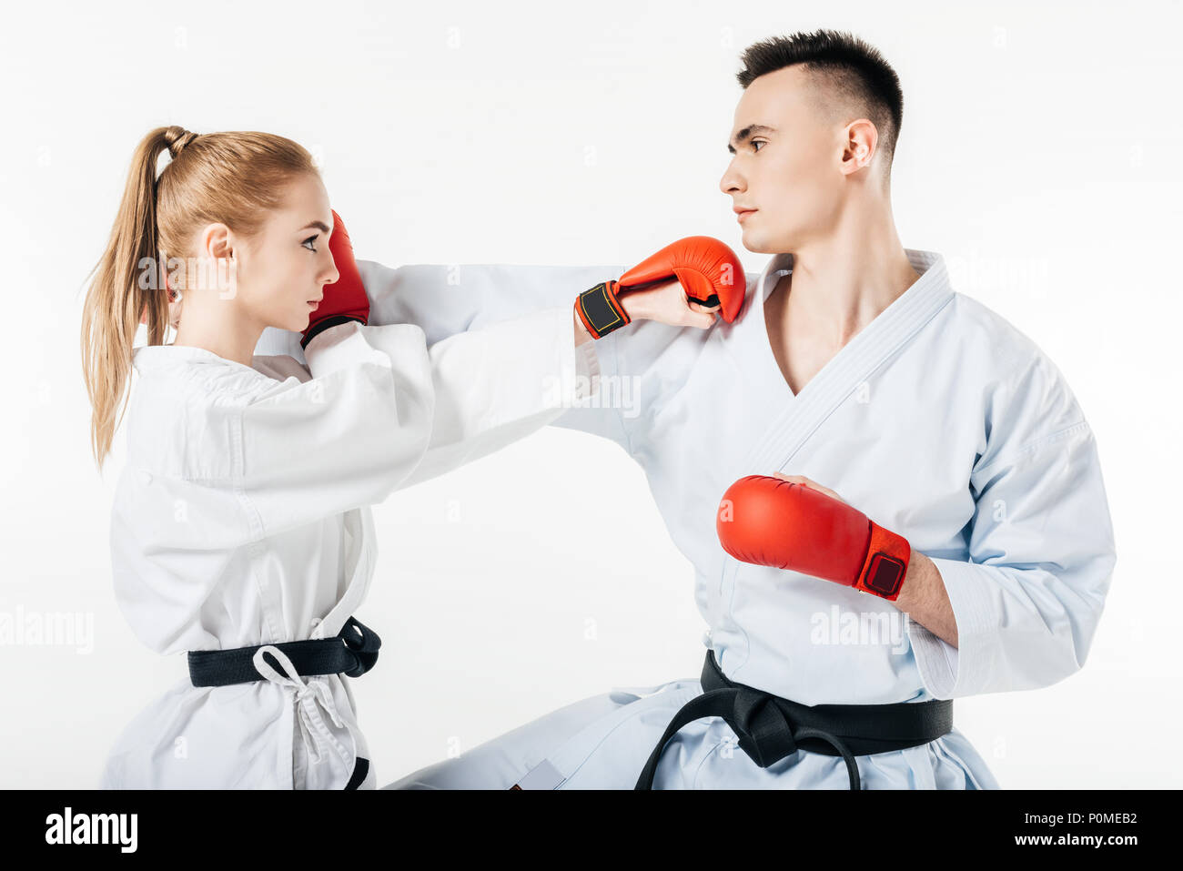 side view of karate fighters exercising isolated on white Stock Photo ...