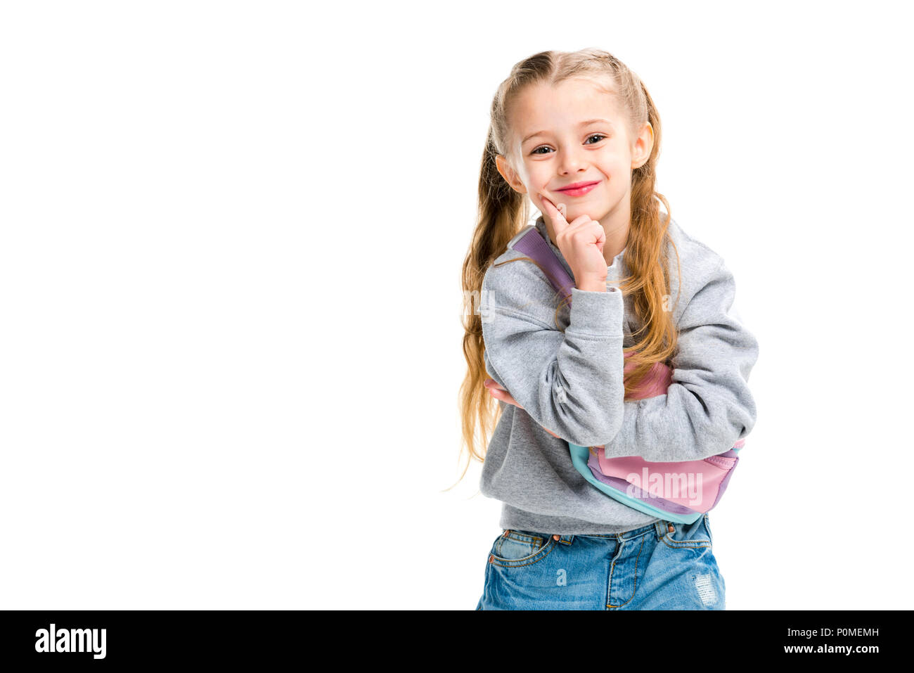 Smiling little child holding finger on chin isolated on white Stock ...