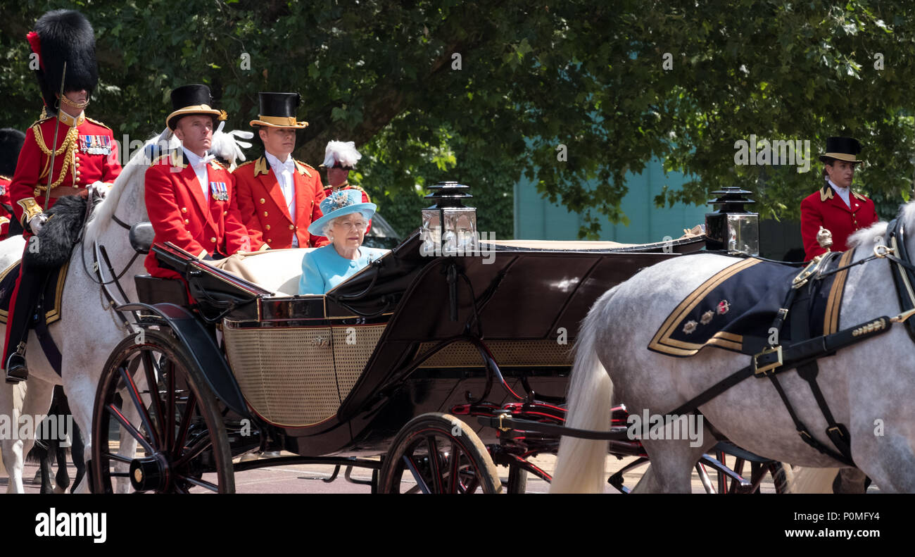 Queen Elizabeth II travels along The Mall in an open carriage pulled by ...