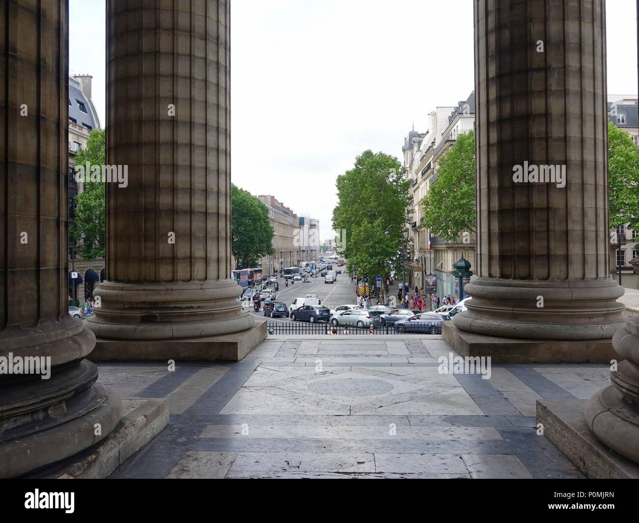 Looking through the enormous stone pillars of the church La Madeleine ...