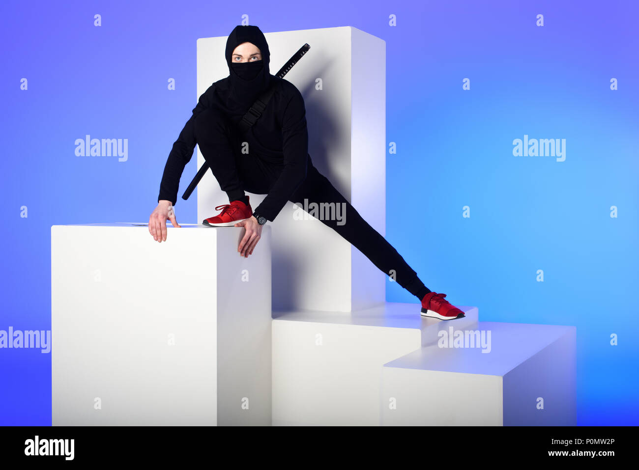 ninja in black clothing with katana behind on white block isolated on ...