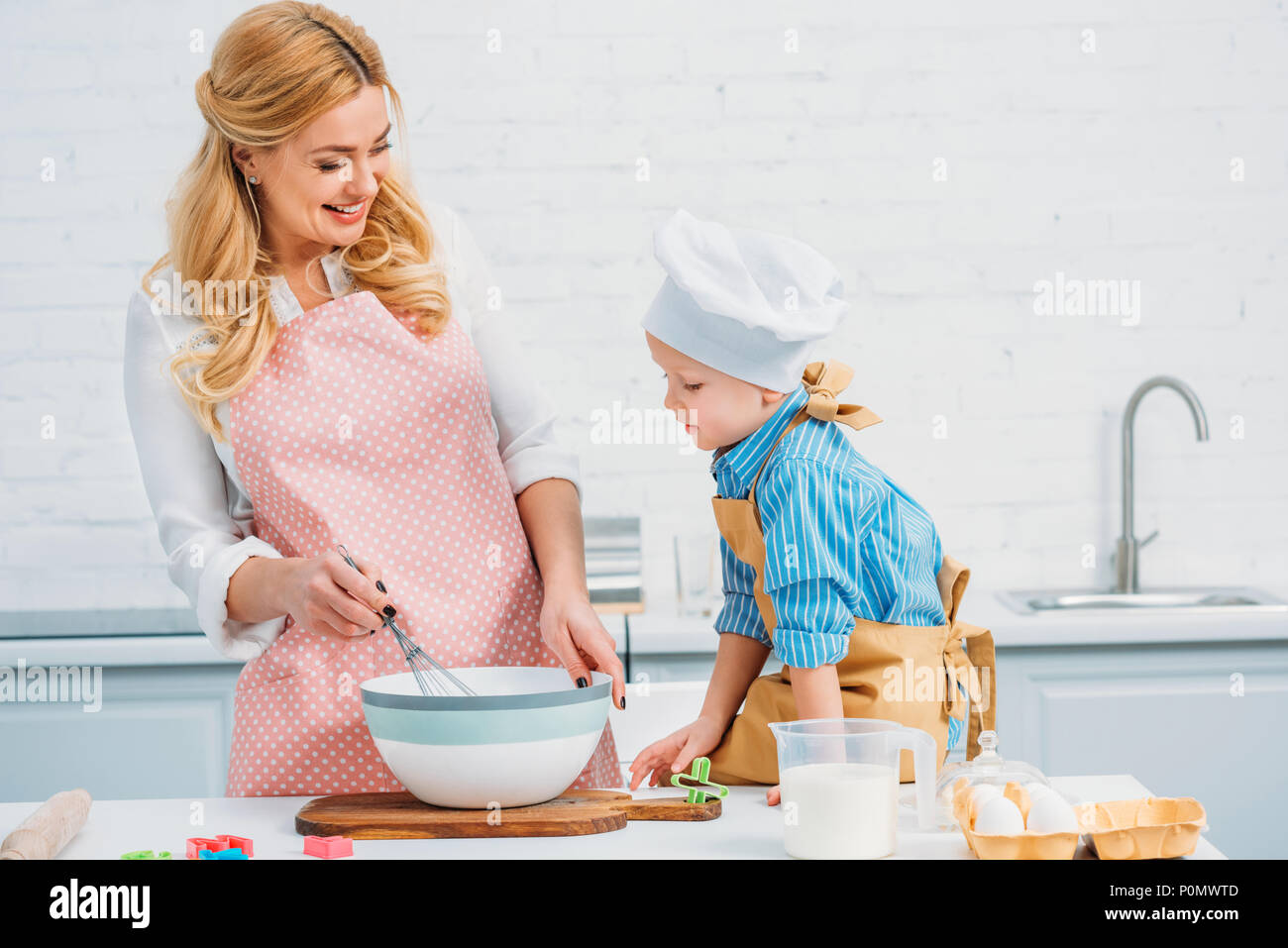 Smiling mother and son in kitchen cooking together Stock Photo - Alamy