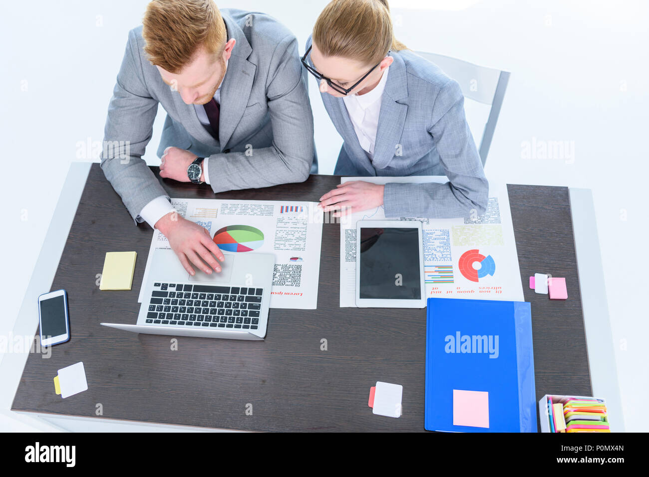 overhead view of businesswoman and businessman working with business ...