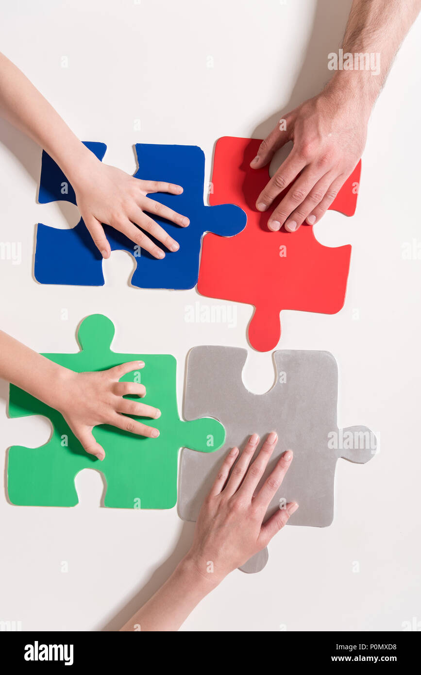 Human hands on colorful puzzle pieces Stock Photo - Alamy