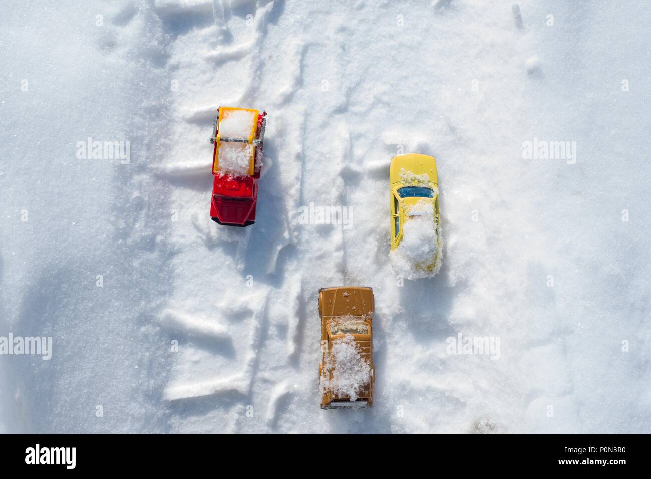 Snow covered cars drive through snow-covered road to snowfall, winter ...
