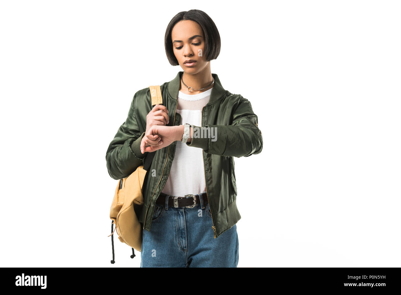 female african american student with backpack looking at wristwatch ...