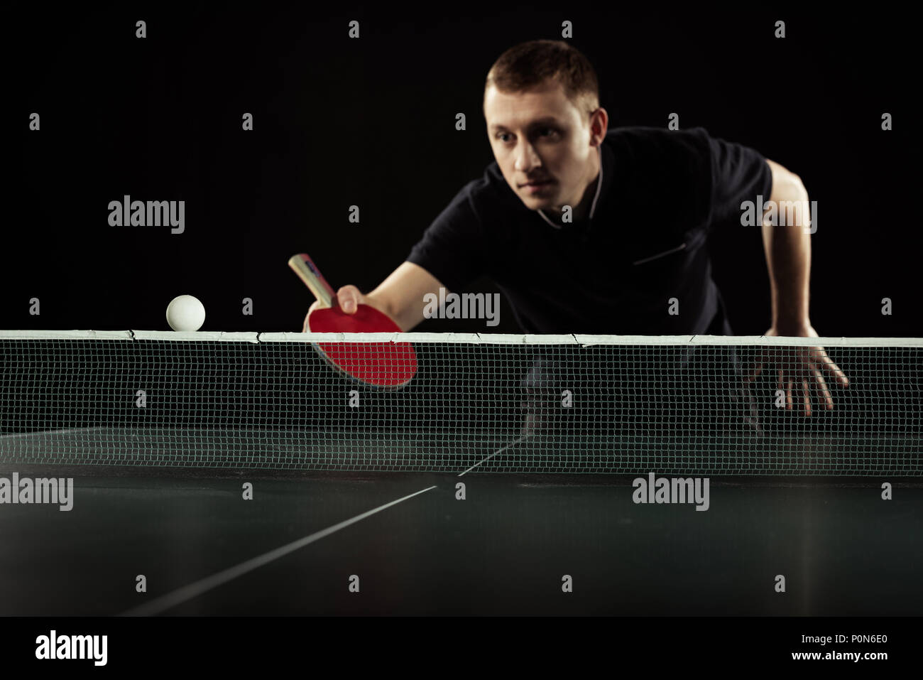 selective focus of focused tennis player in uniform playing table ...