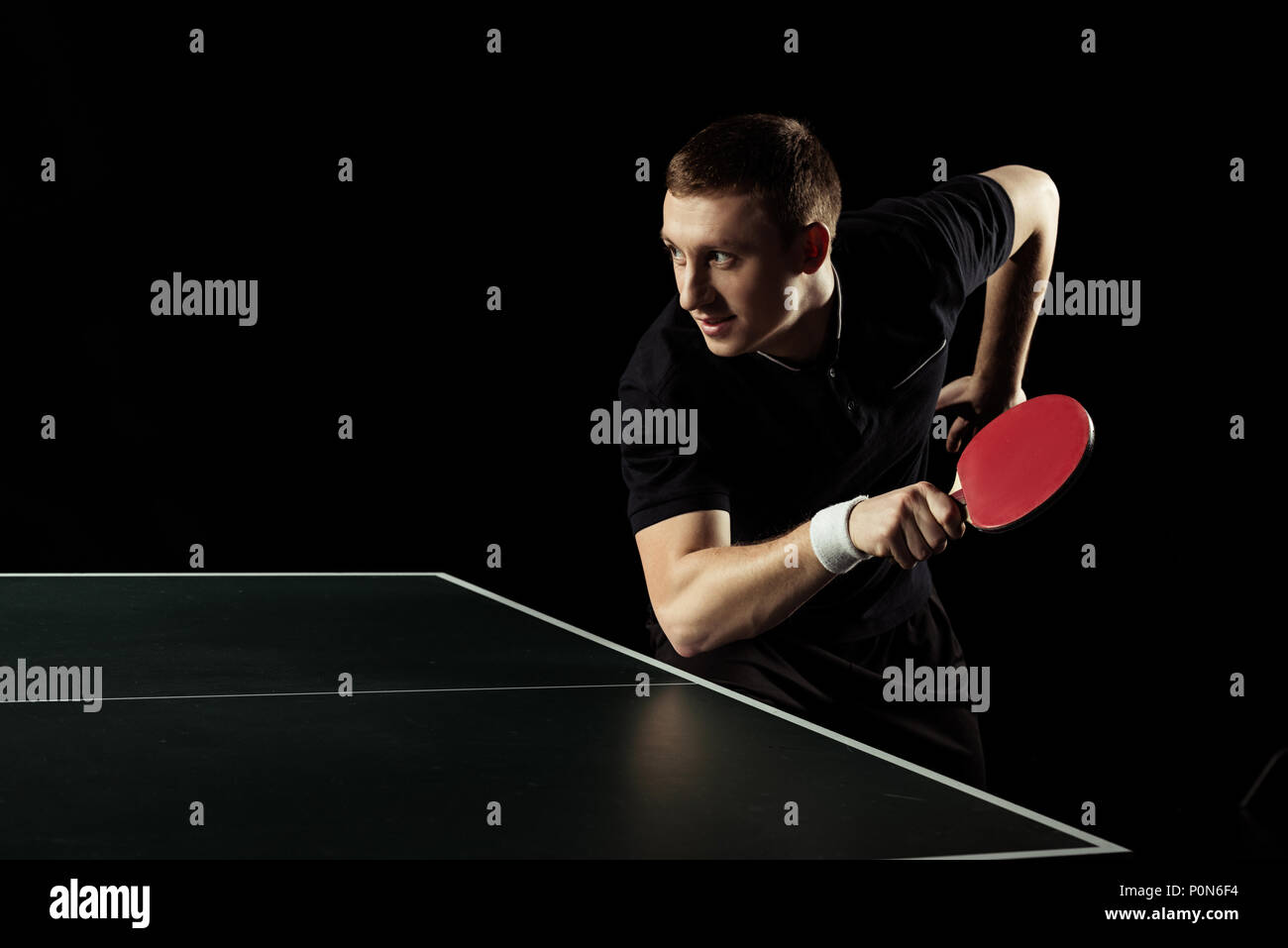 side view of young tennis player practicing in table tennis isolated on ...