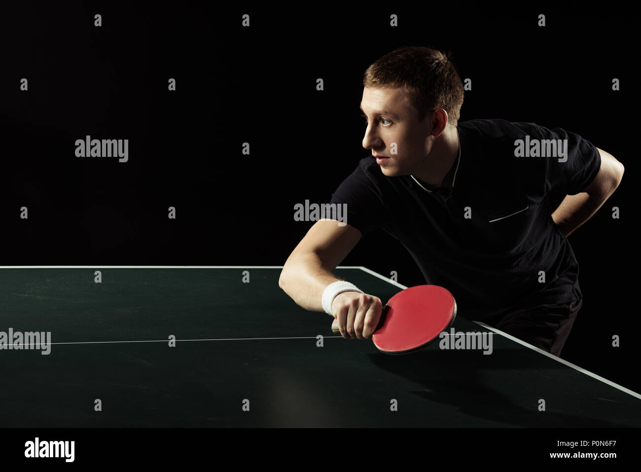 side view of young tennis player practicing in table tennis isolated on ...