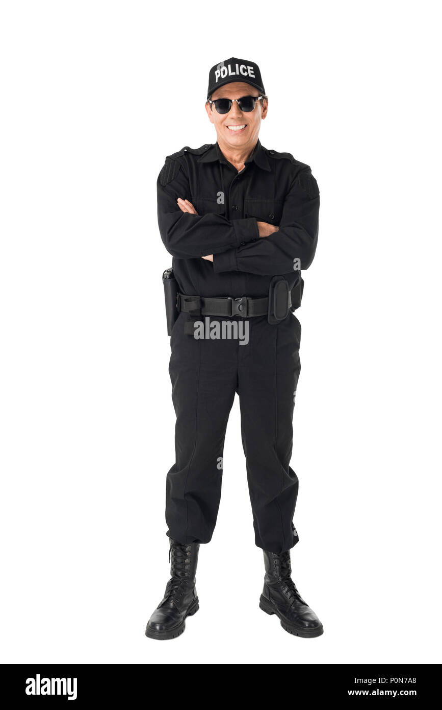 Smiling policeman with arms folded isolated on white Stock Photo - Alamy