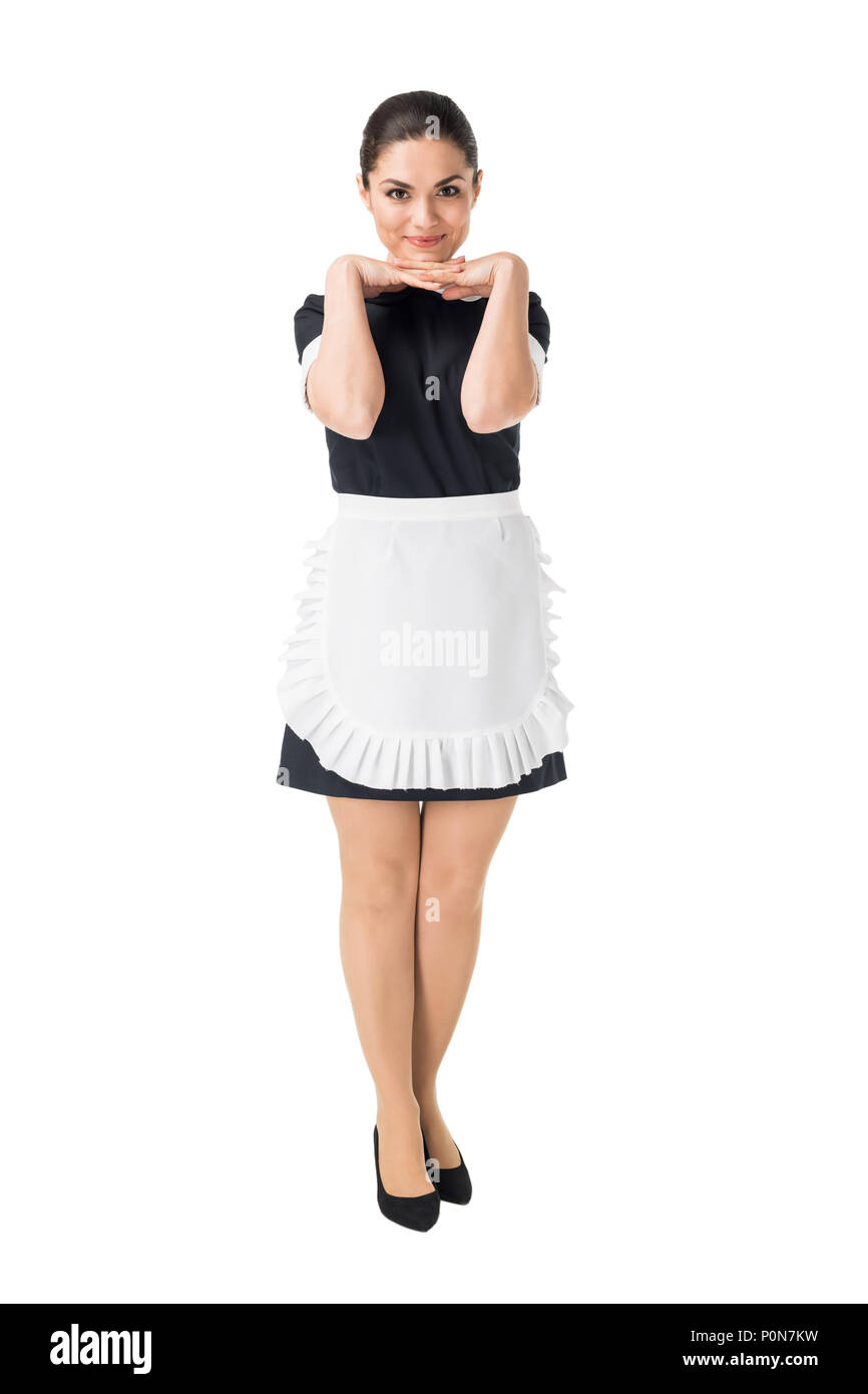 Smiling maid in professional uniform with hands by face isolated on ...