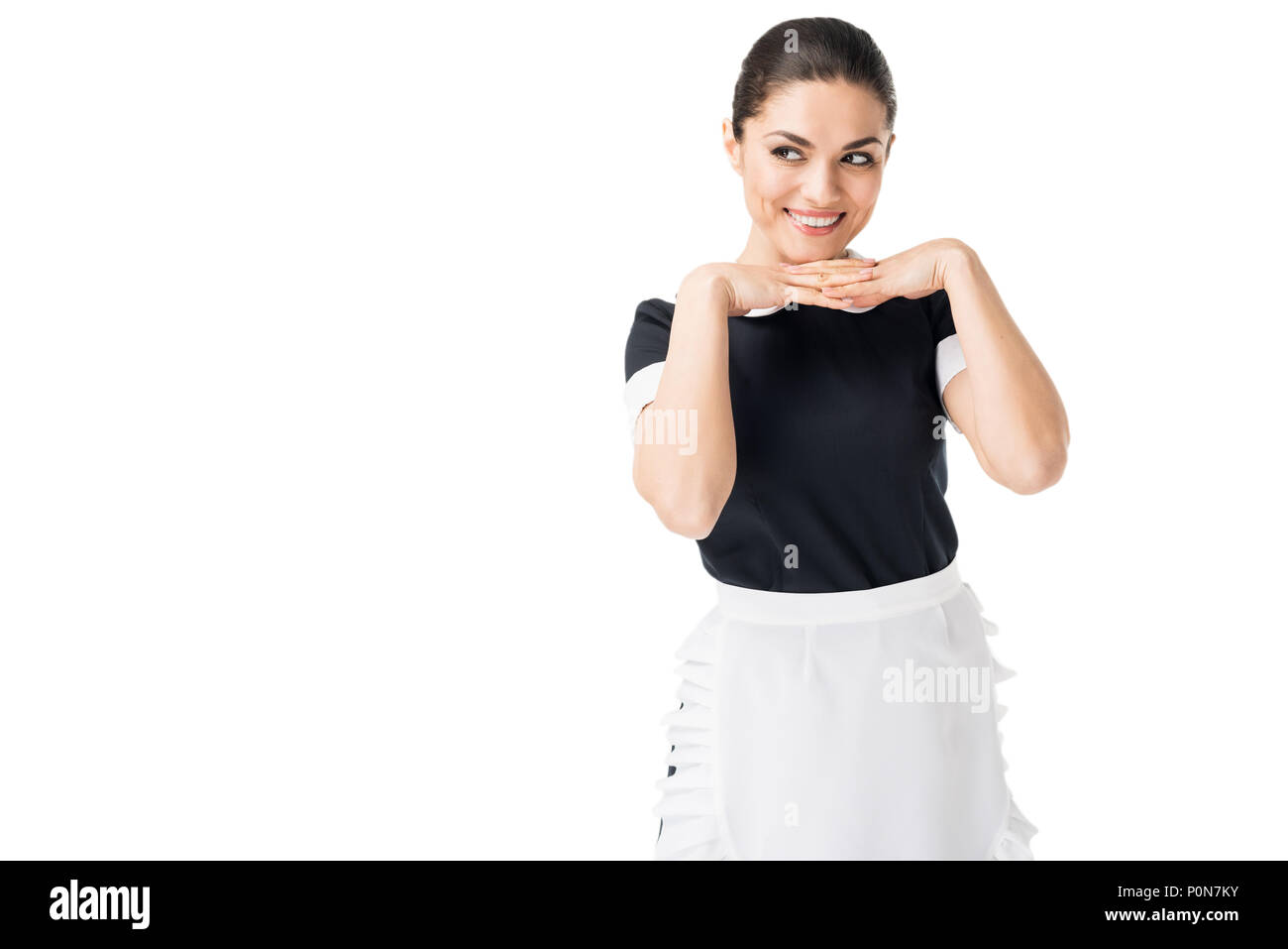 Smiling maid in professional uniform with hands by face isolated on ...