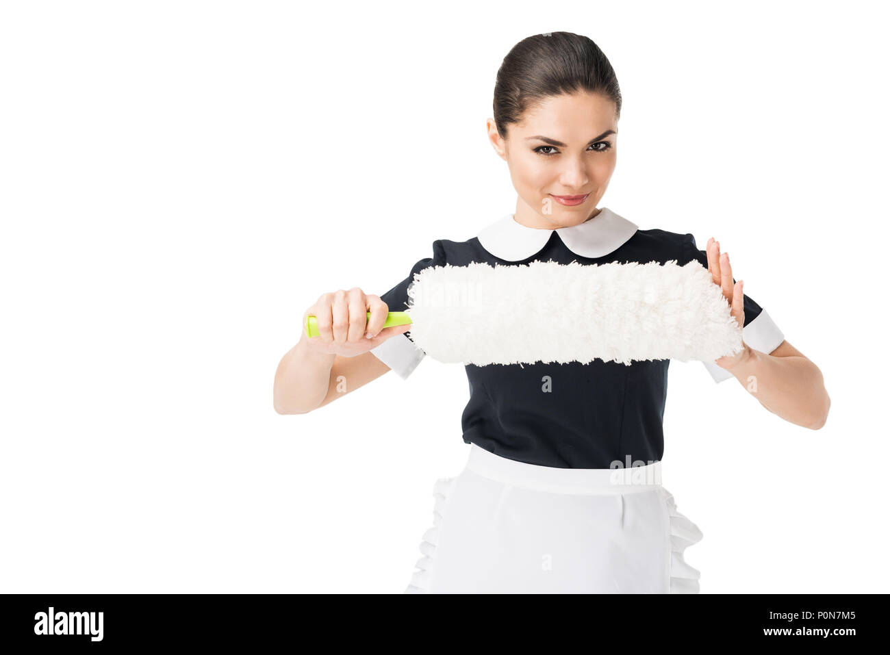 Professional maid in uniform holding duster isolated on white Stock ...