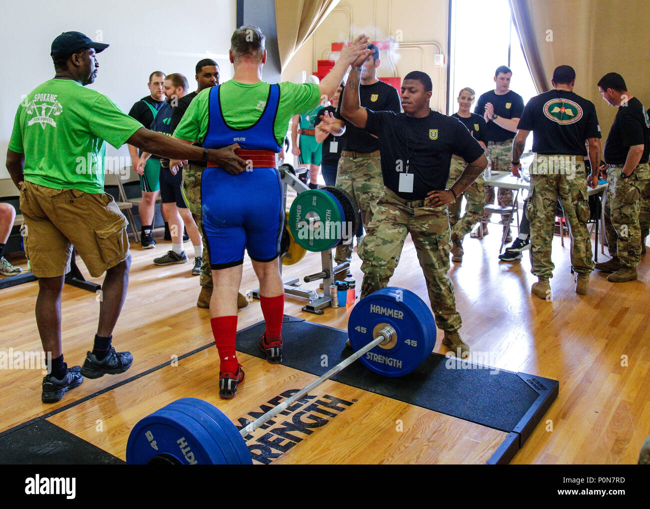 A volunteer from the 1st Special Forces Group (Airborne) congratulates ...