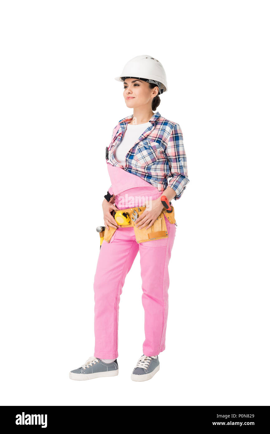 Attractive female builder in pink uniform with tool belt isolated on ...