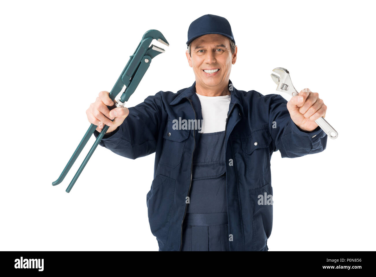 Professional plumber in overalls holding wrenches isolated on white ...