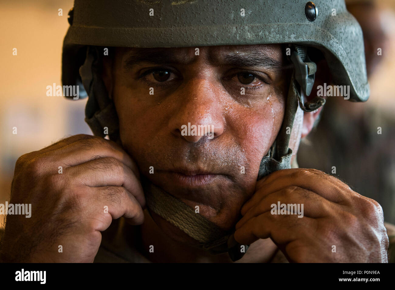 U.S. Army Maj. Benjamin Kenion adjusts his gear in preparation for the ...
