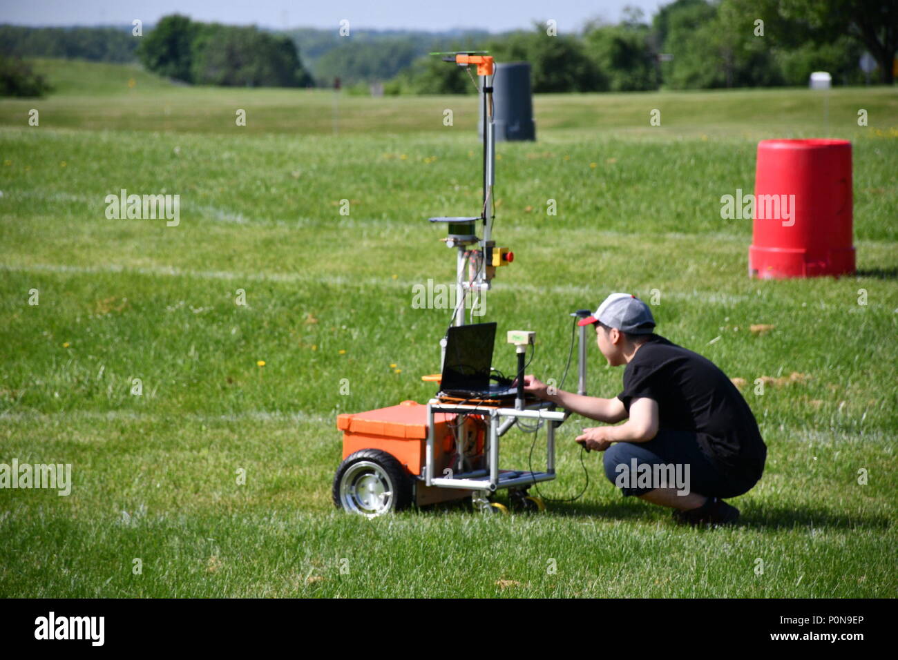A robotics student double-checks systems on his autonomous vehicle ...
