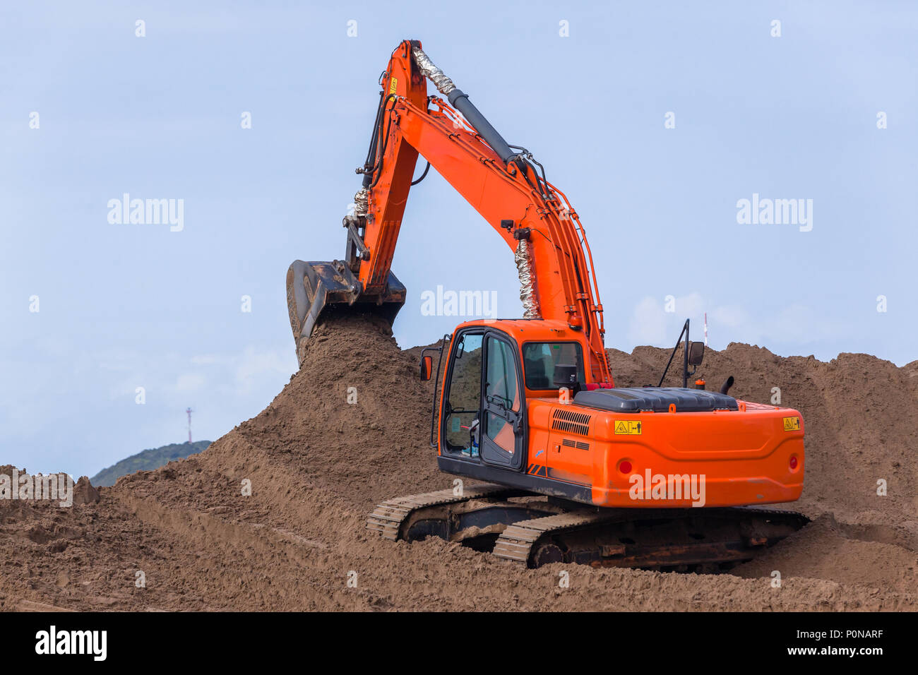 Earthworks construction heavy excavator machine moving sand closeup ...