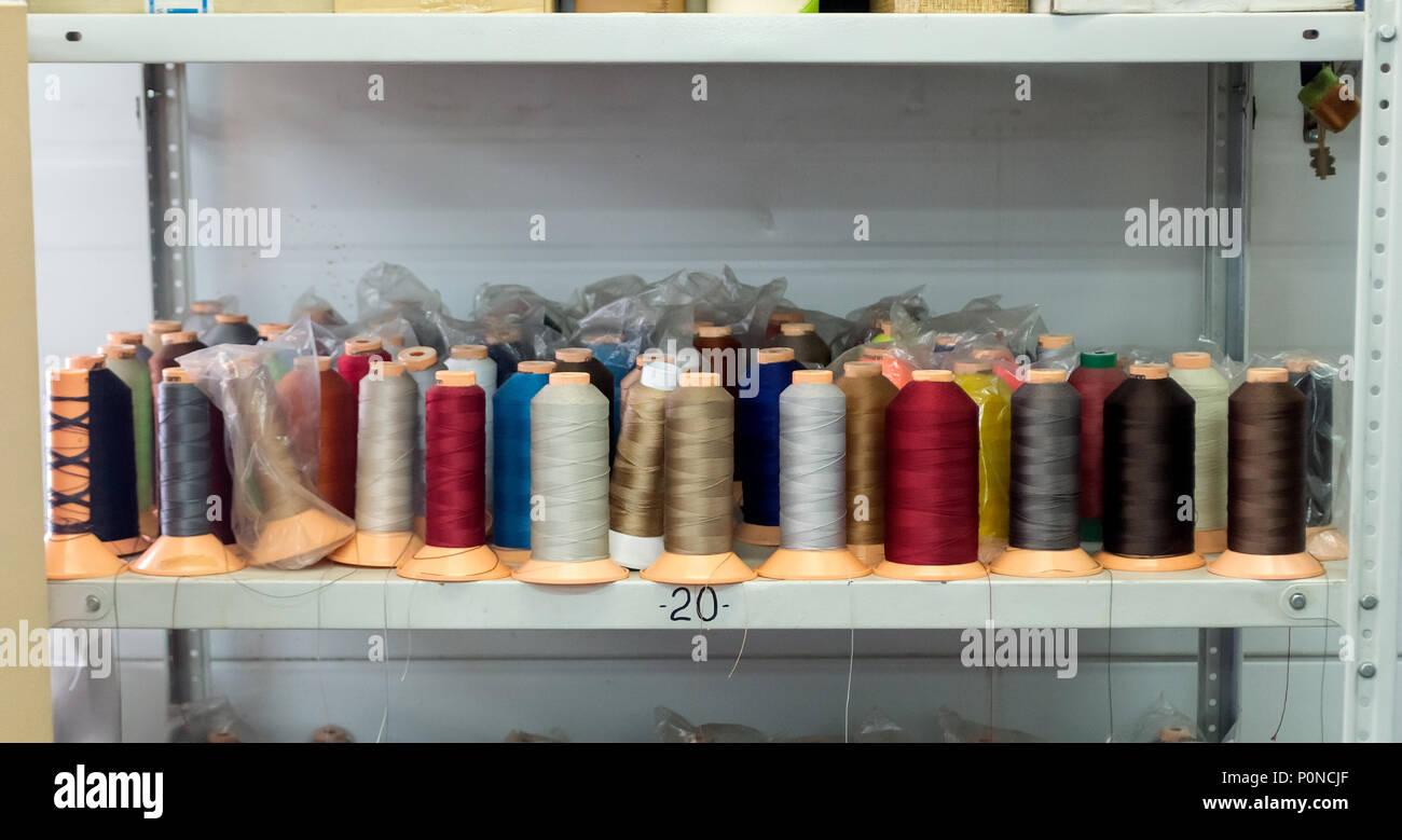 Colored threads in sewing workshop hi-res stock photography and images ...