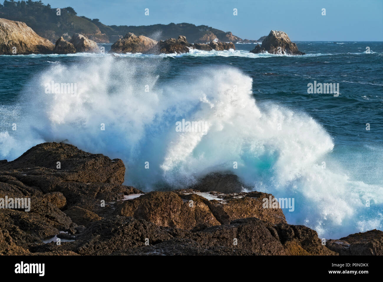Large evening waves crash against the rocky cove at Point Lobos State ...