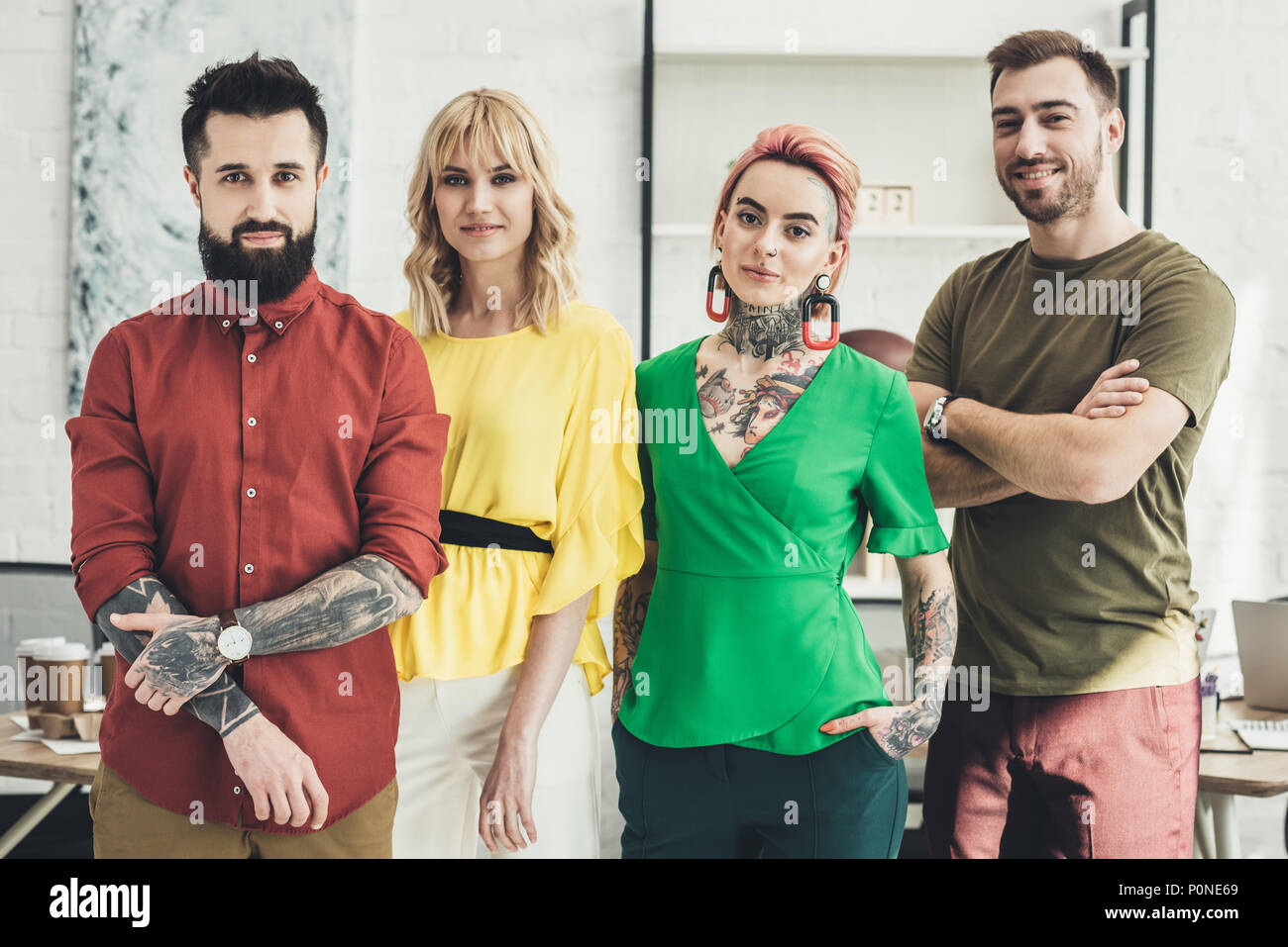 portrait of group of young stylish creative workers looking at camera ...