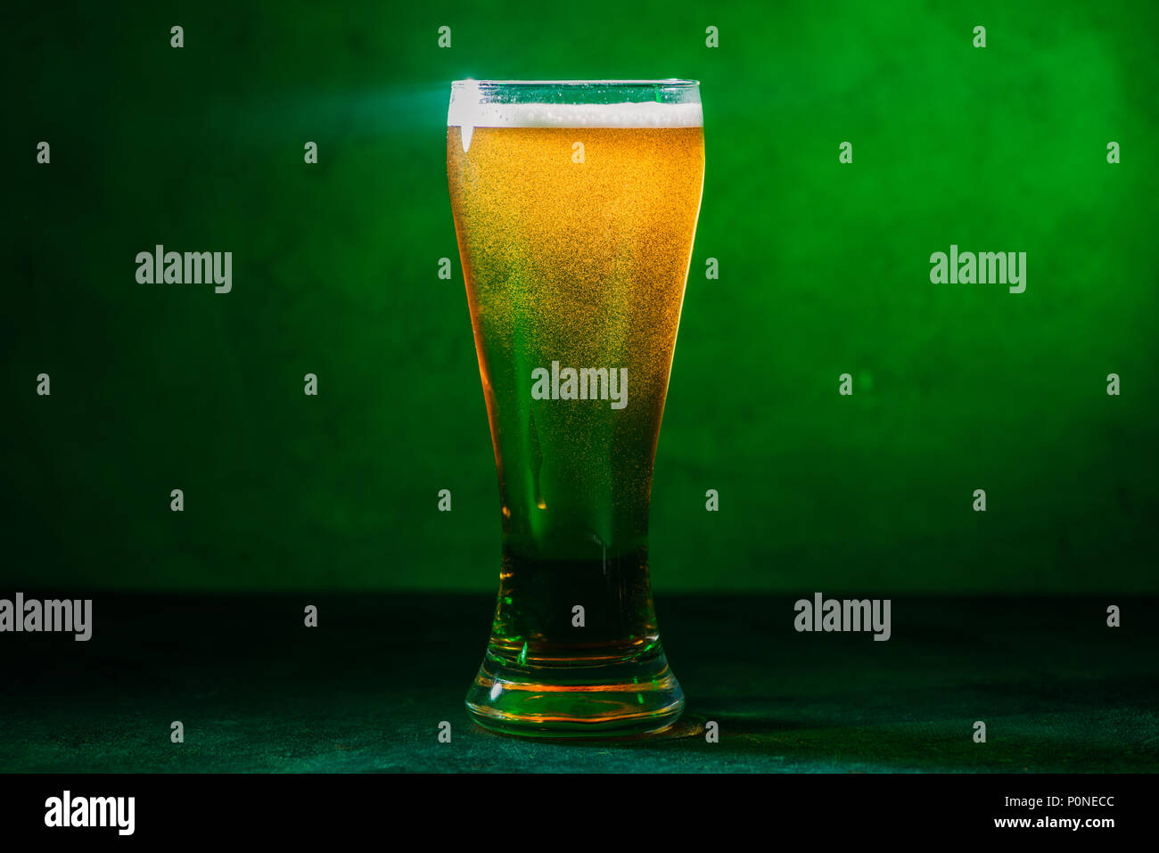 close-up view of glass with fresh cold amber beer on green Stock Photo ...