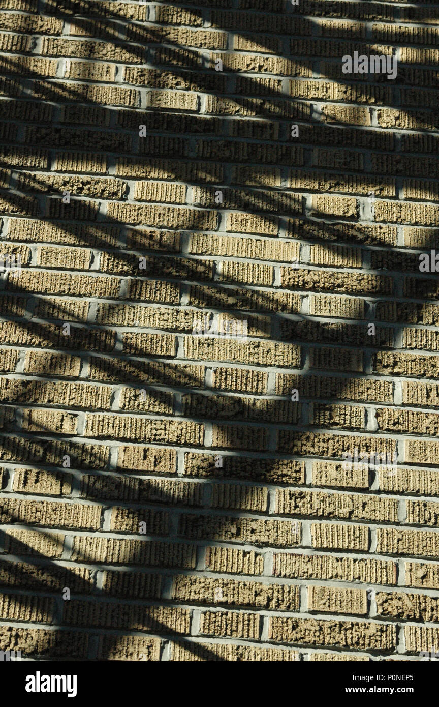 Shadow cast by a fire escape against a brick wall on a building in NYCâ ...