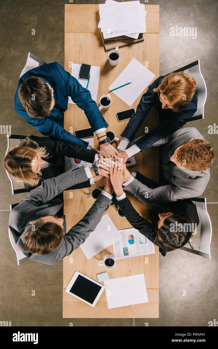 overhead view of business partners at table in office, businesspeople ...