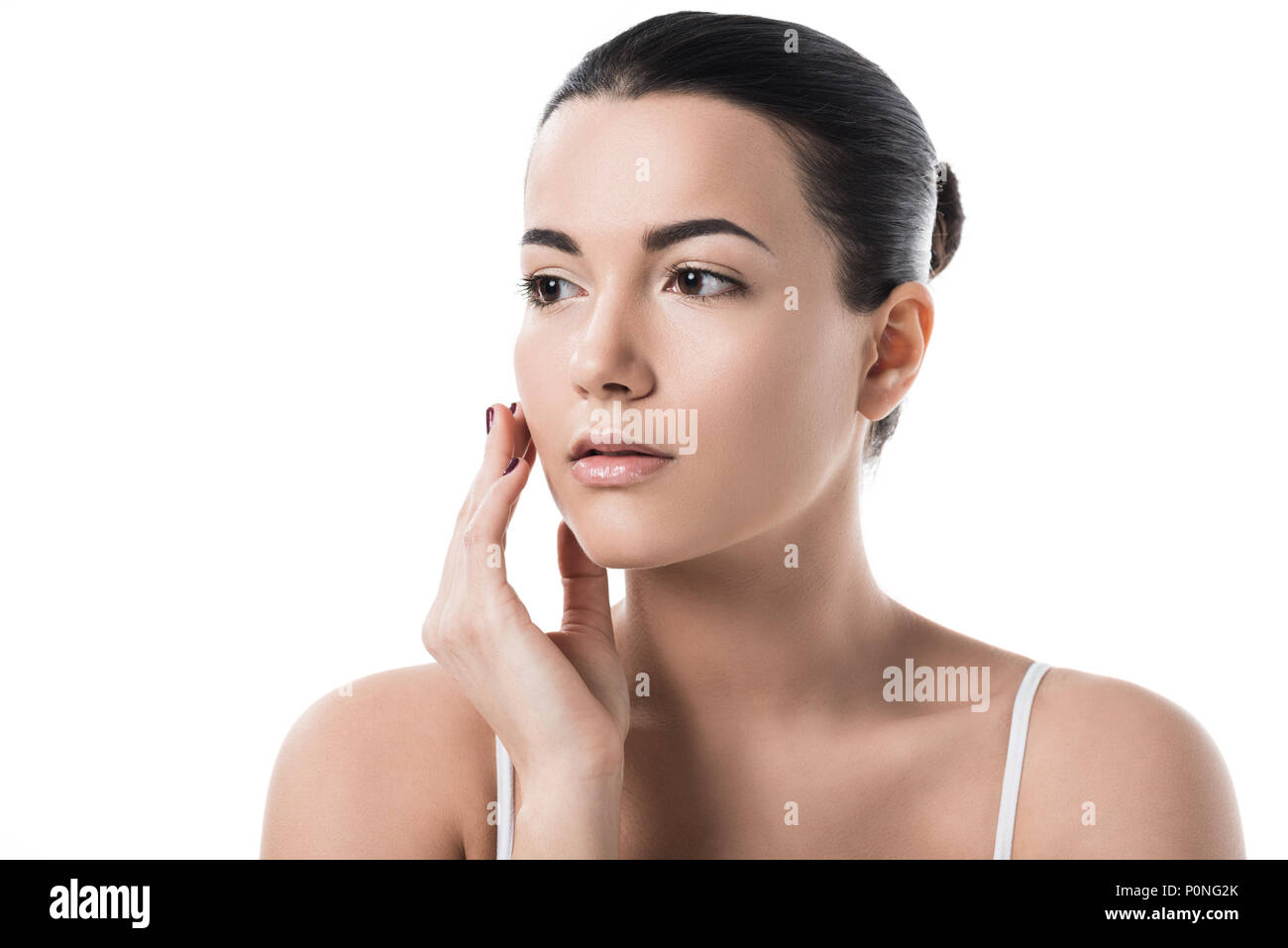 beautiful girl touching face with hand and looking away isolated on ...