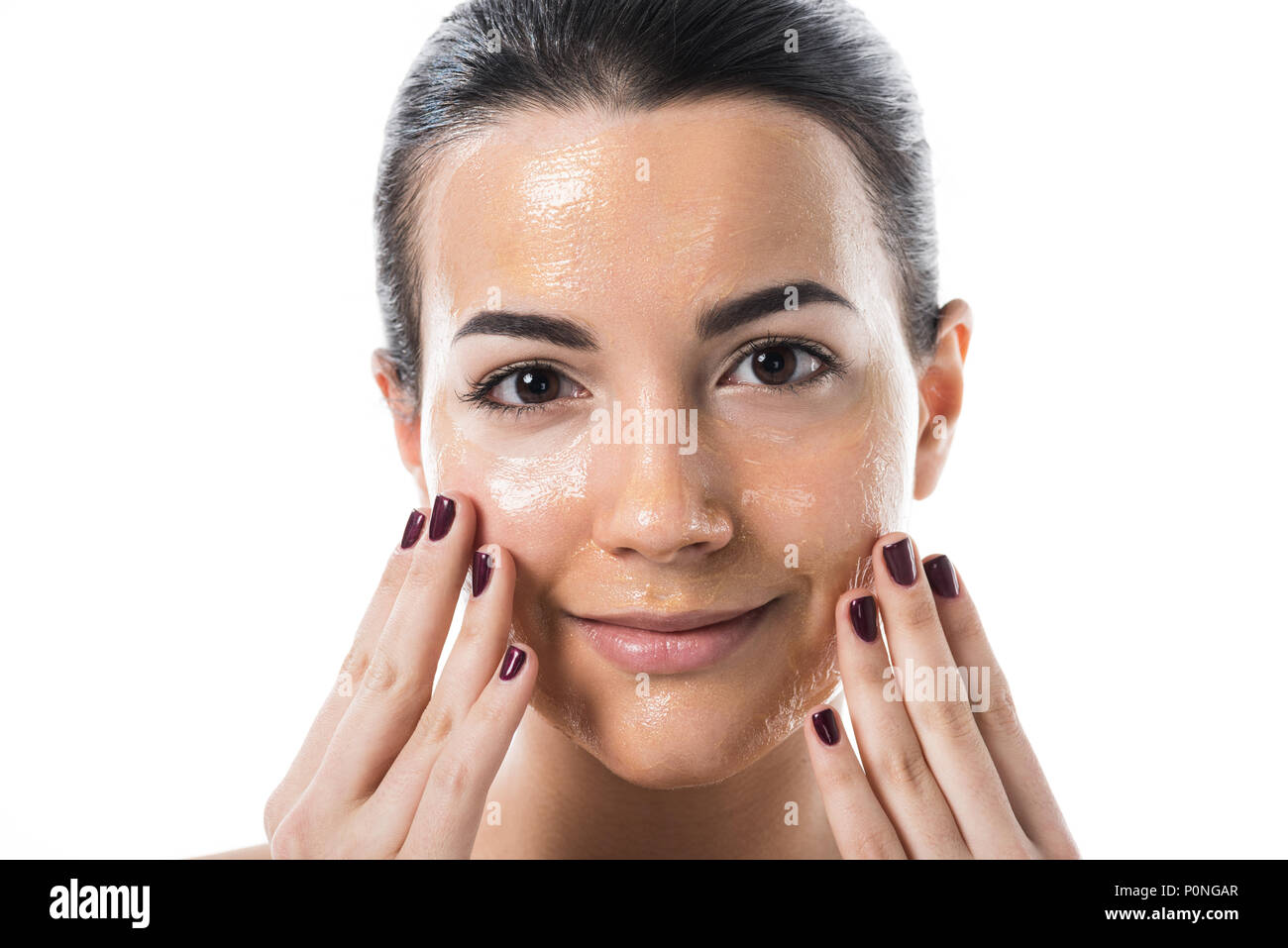 Beautiful Girl Touching Face With Honey Mask And Looking At Camera