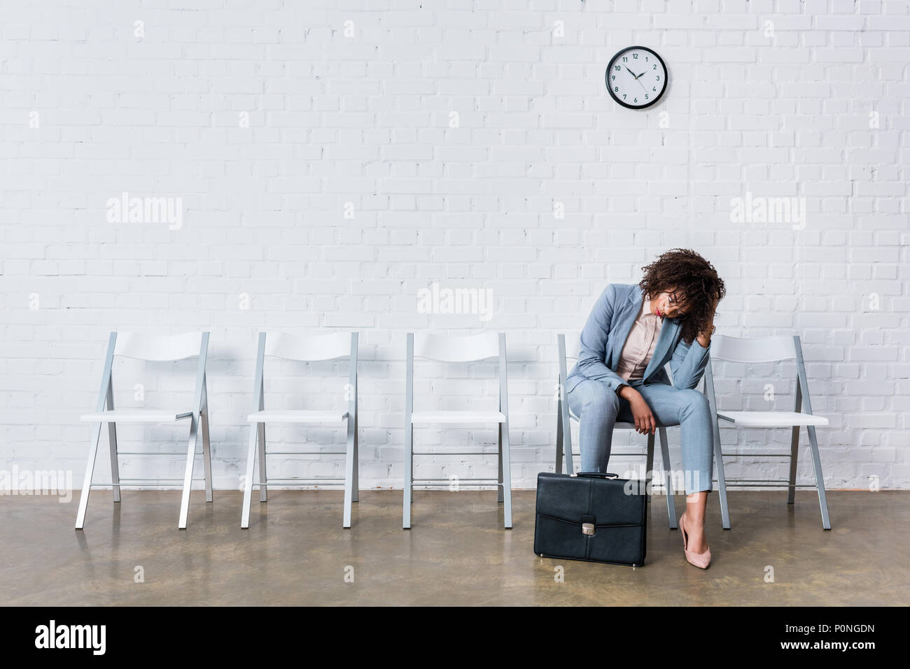 Tired female candidate with briefcase waiting for interview Stock Photo ...