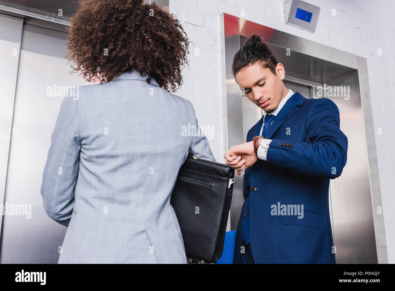 African american businessman checking his watch and waiting for ...