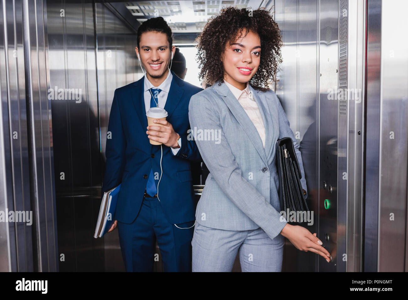 Woman pushing elevator button hi-res stock photography and images - Alamy