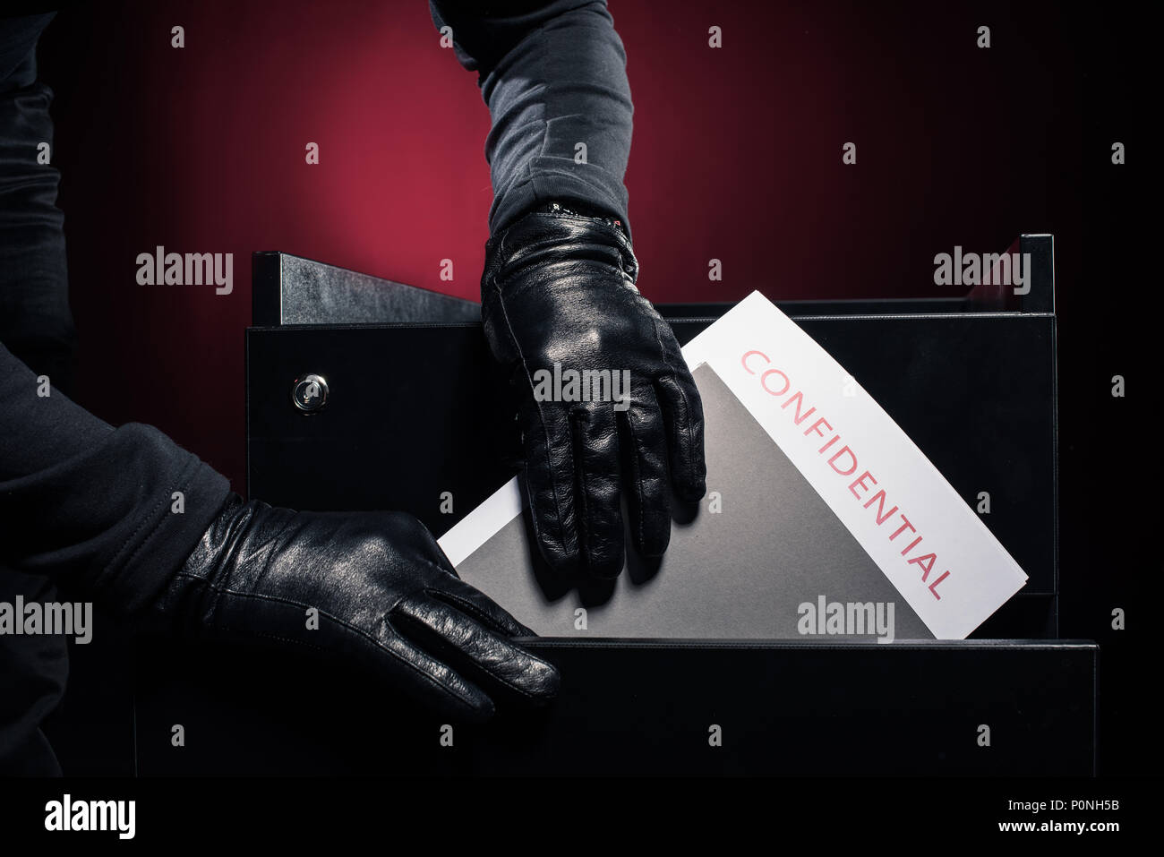 Close-up view of man stealing top secret papers Stock Photo - Alamy