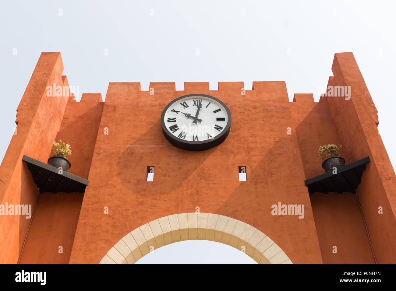 The wall with big clock on sky background Stock Photo - Alamy