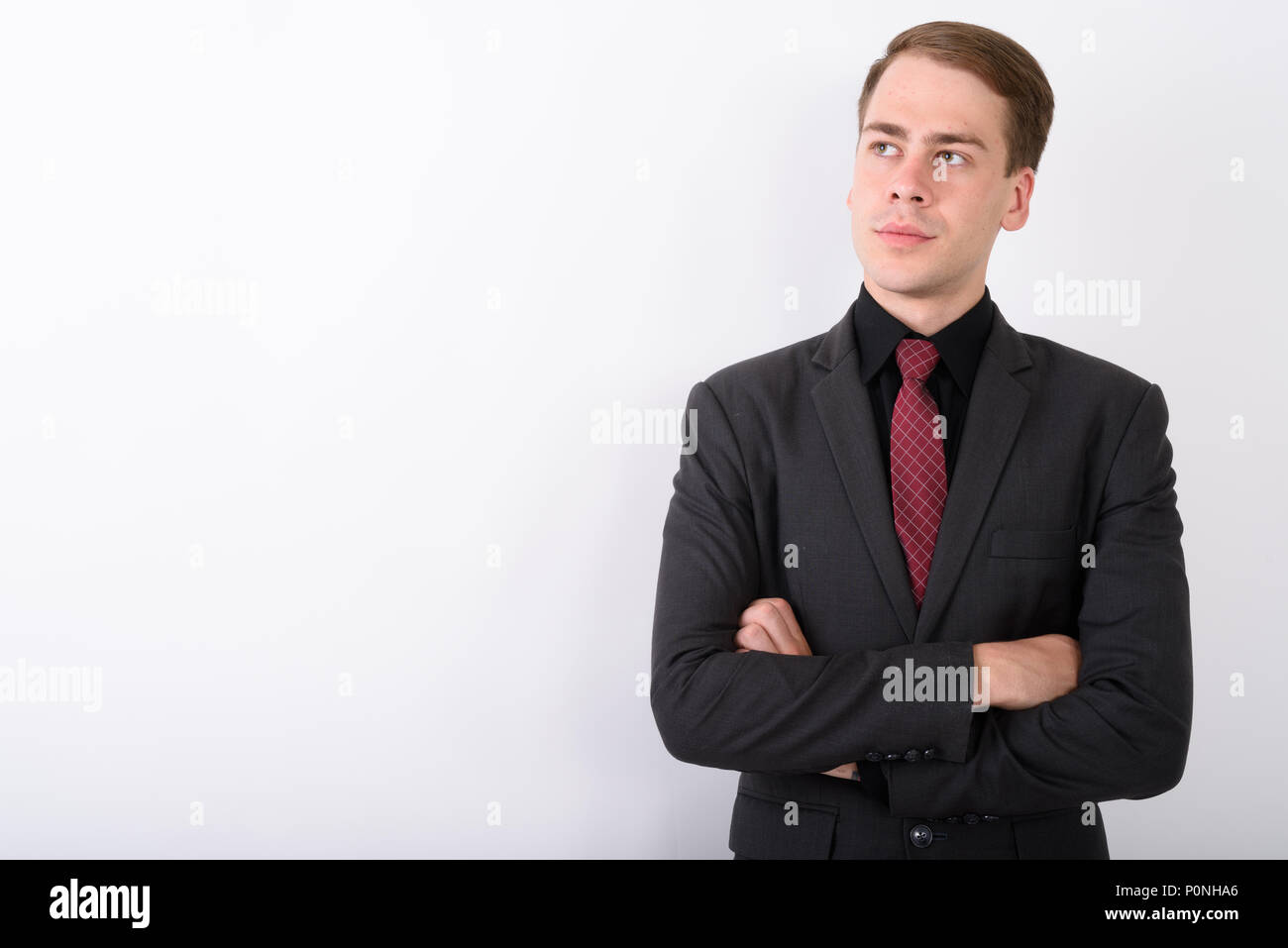Young handsome businessman wearing suit against white background Stock ...