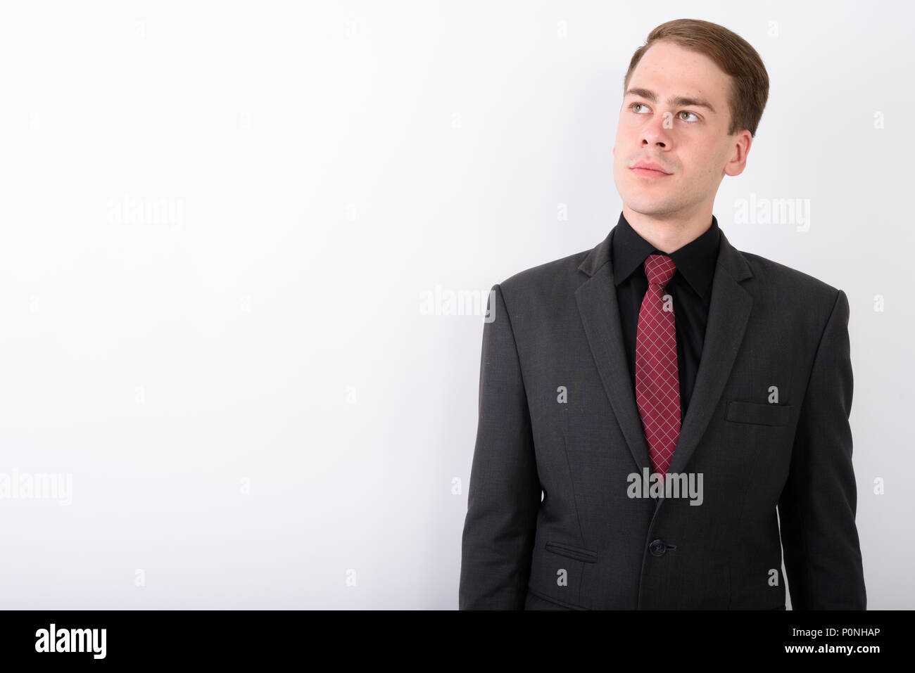 Young handsome businessman wearing suit against white background Stock ...