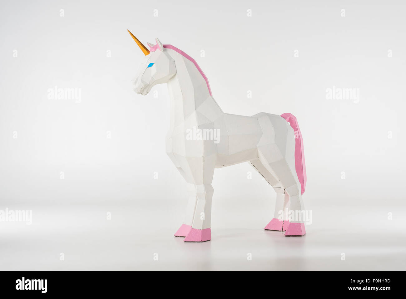 unicorn toy with golden horn with pink hooves on white Stock Photo - Alamy
