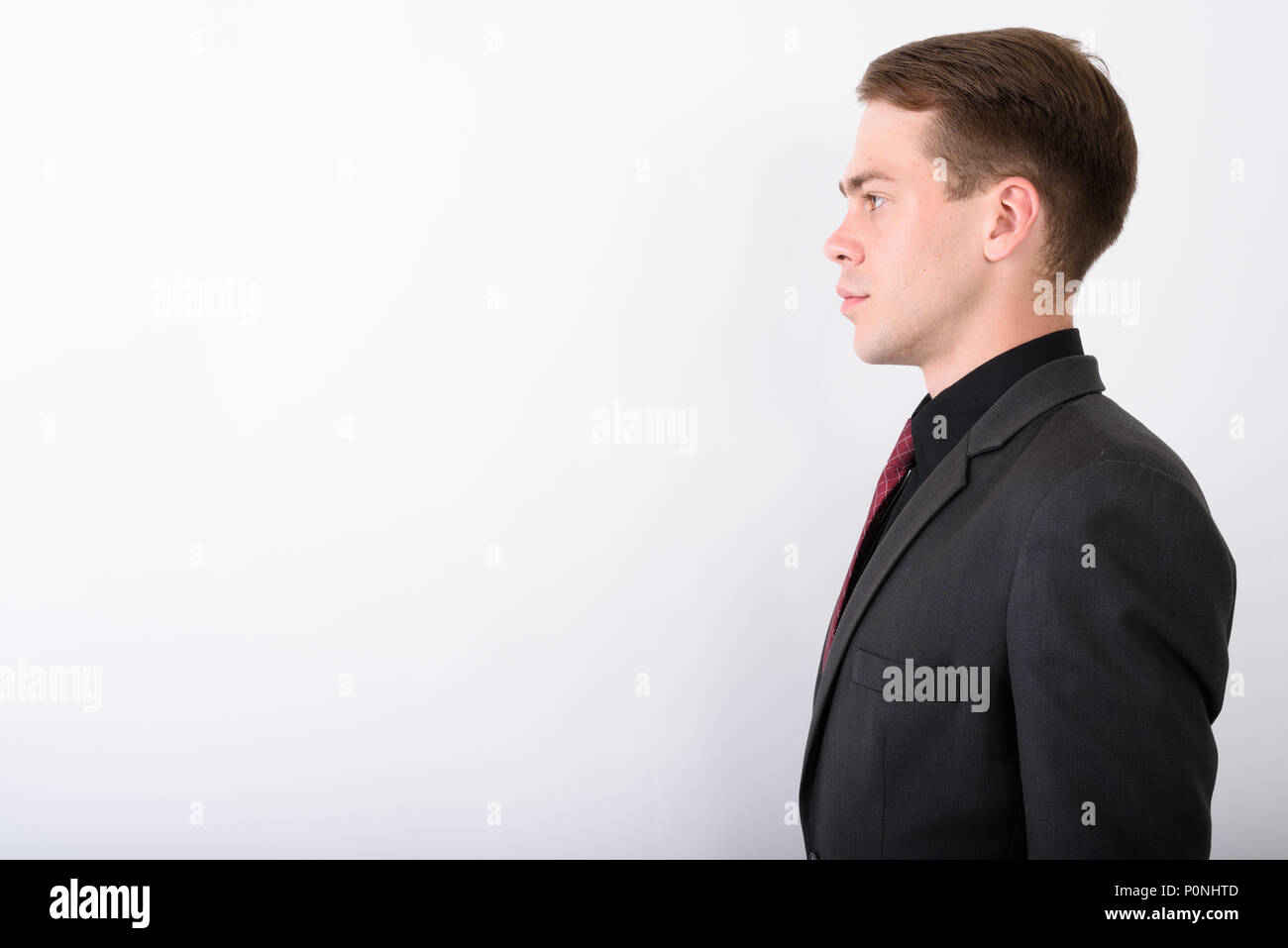 Young handsome businessman wearing suit against white background Stock ...