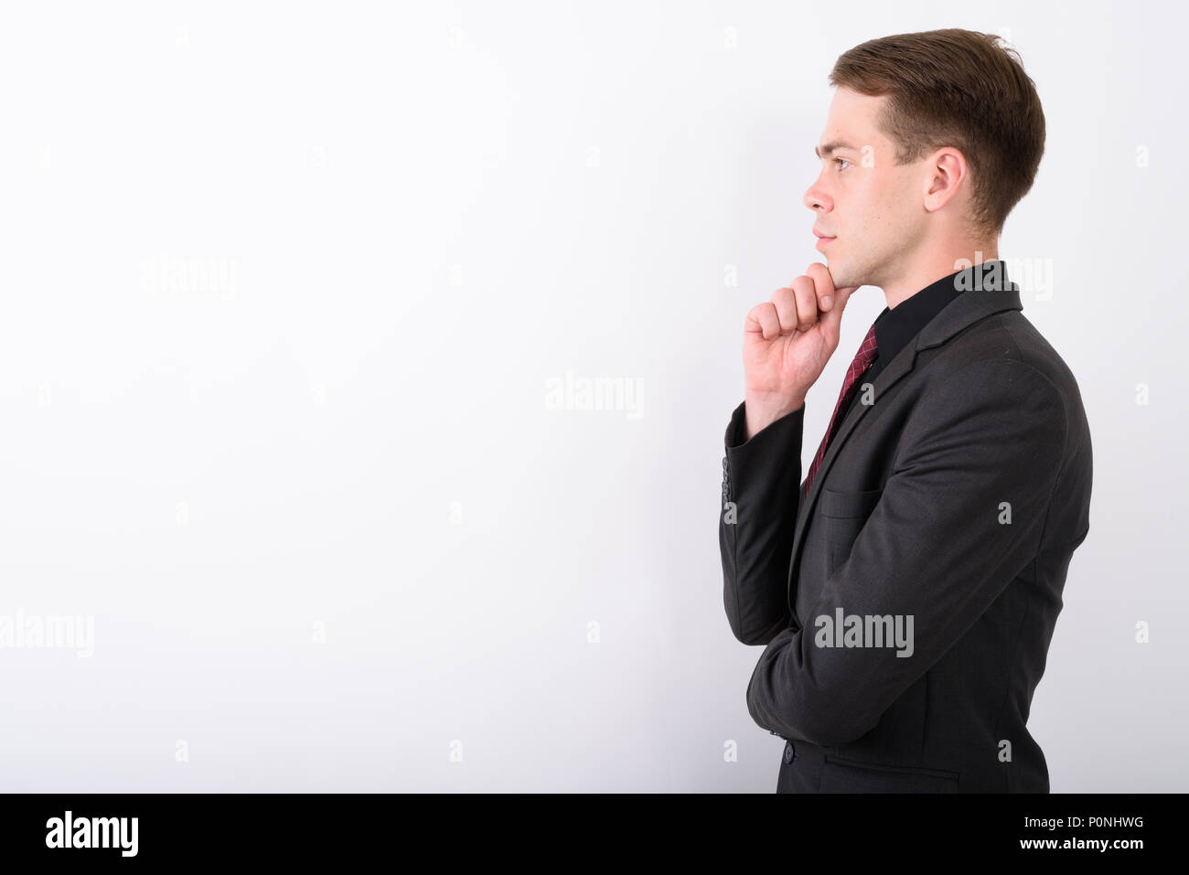 Young handsome businessman wearing suit against white background Stock ...