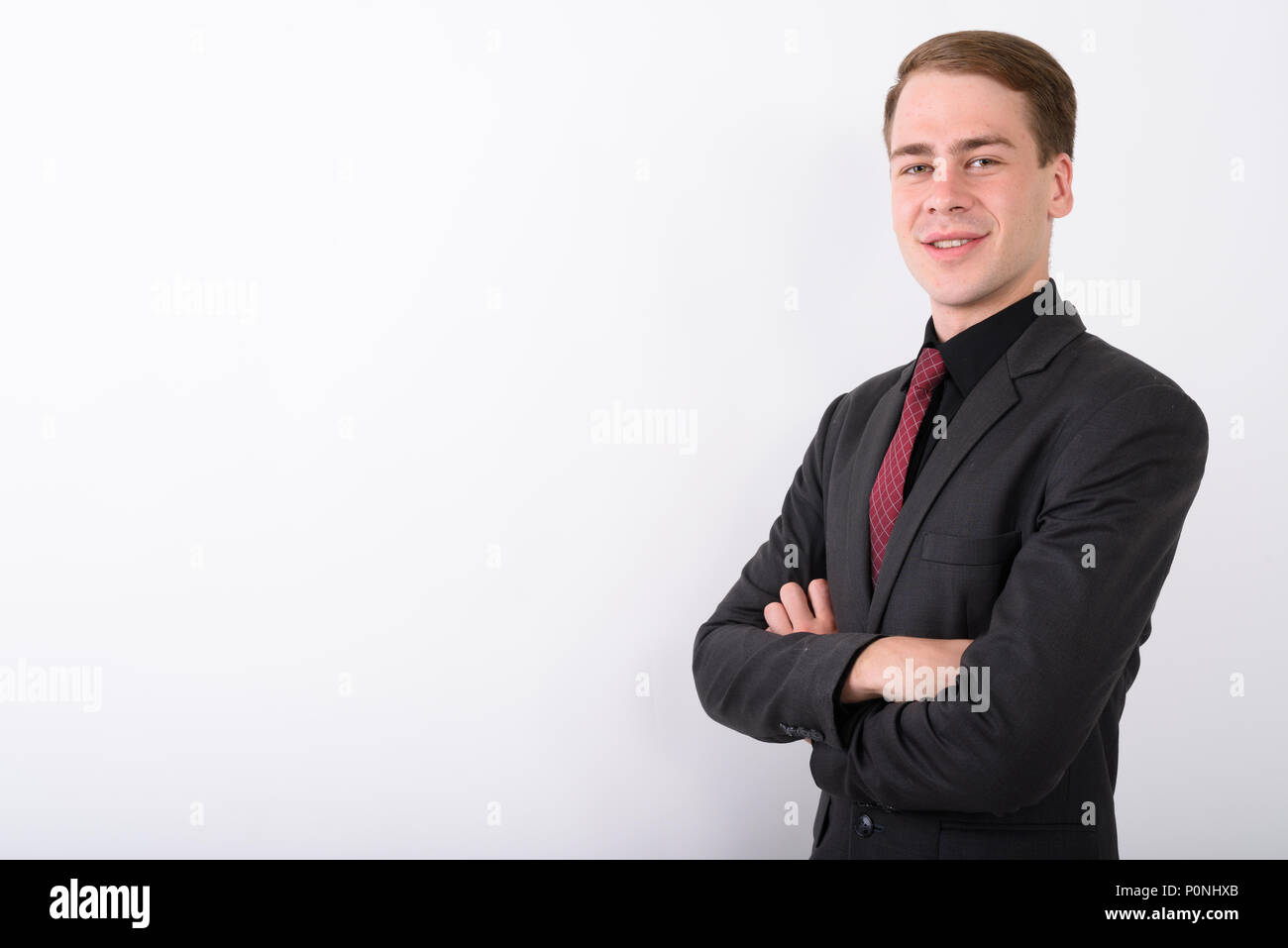 Young handsome businessman wearing suit against white background Stock ...