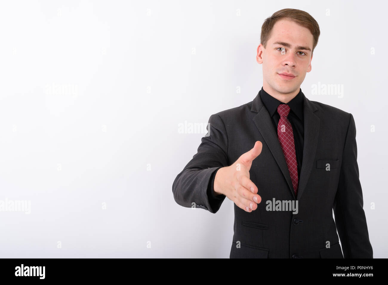 Young handsome businessman wearing suit against white background Stock ...