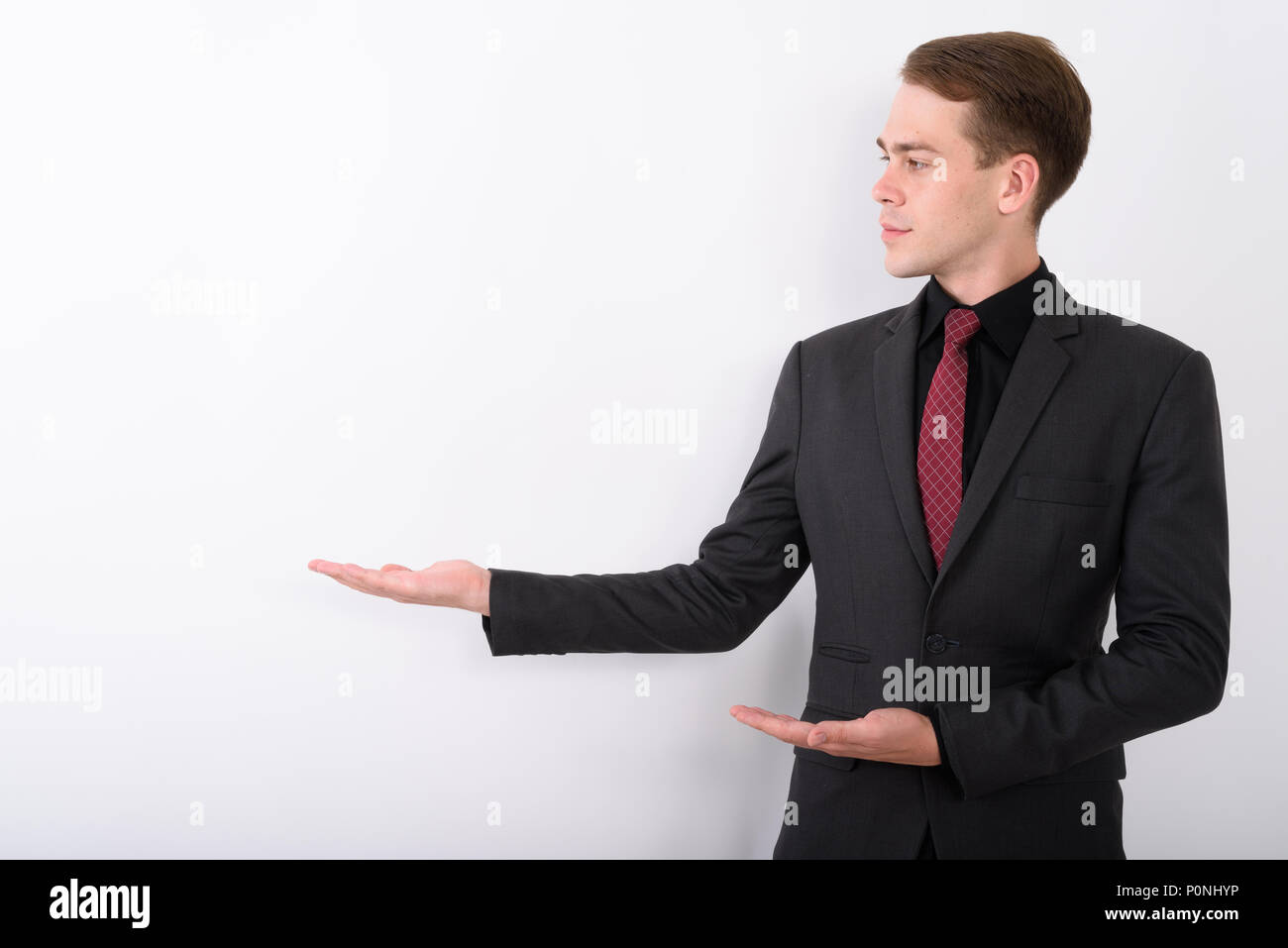 Young handsome businessman wearing suit against white background Stock ...