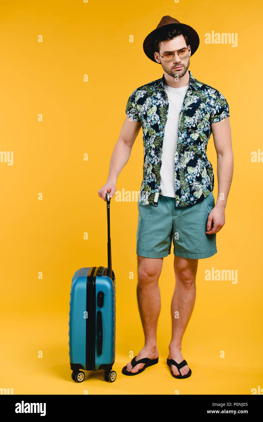 full length view of handsome young man in summer outfit holding ...