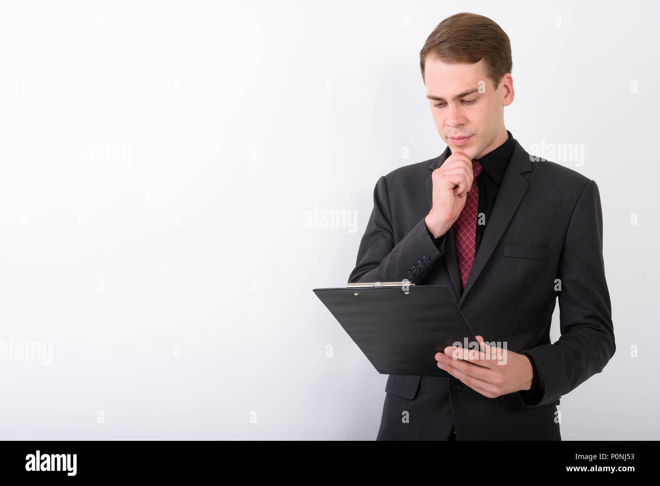 Young handsome businessman wearing suit against white background Stock ...