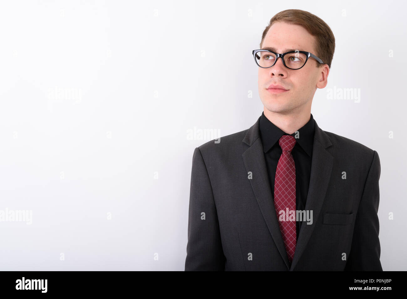 Young handsome businessman wearing suit against white background Stock ...