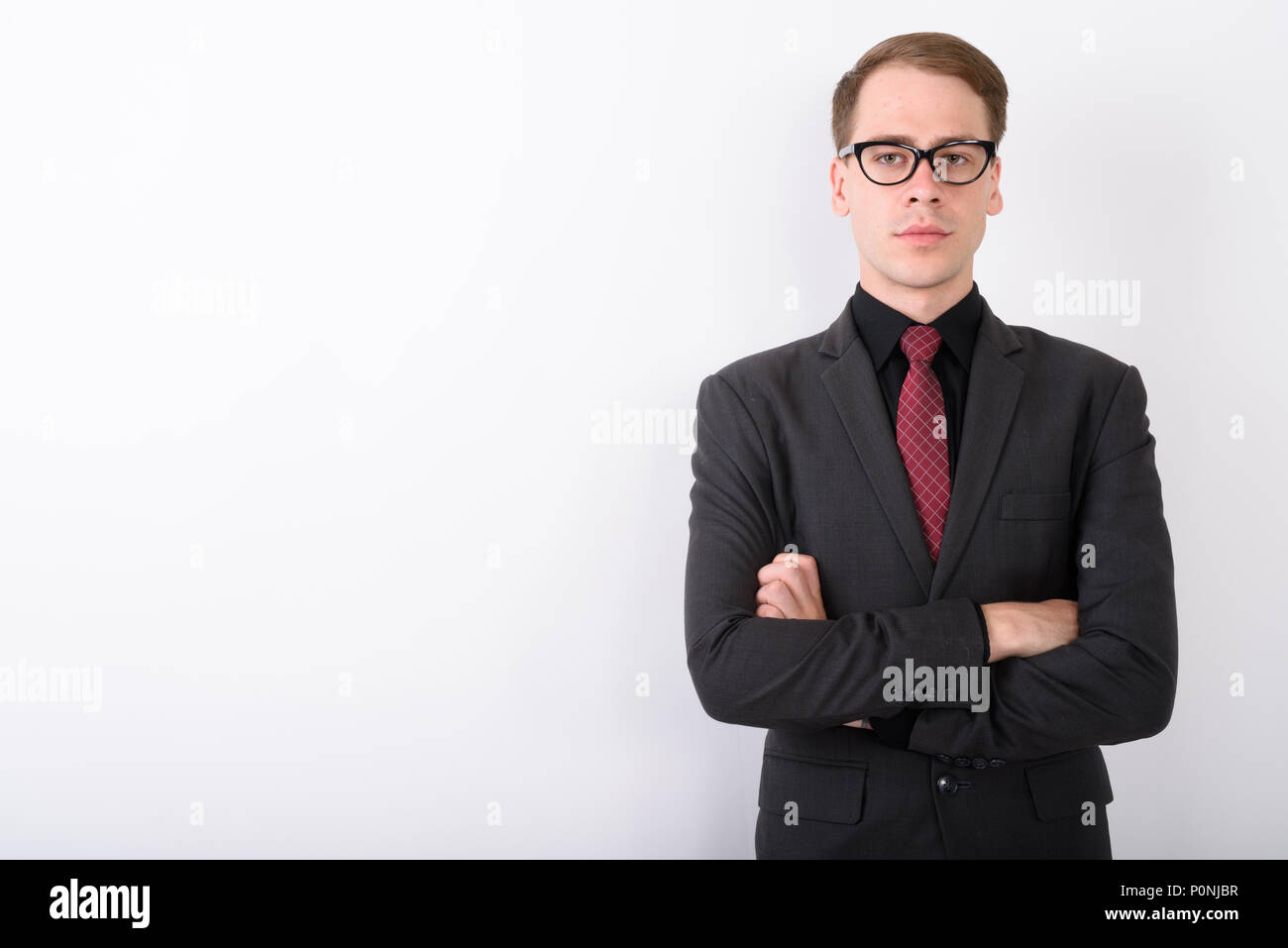 Young handsome businessman wearing suit against white background Stock ...
