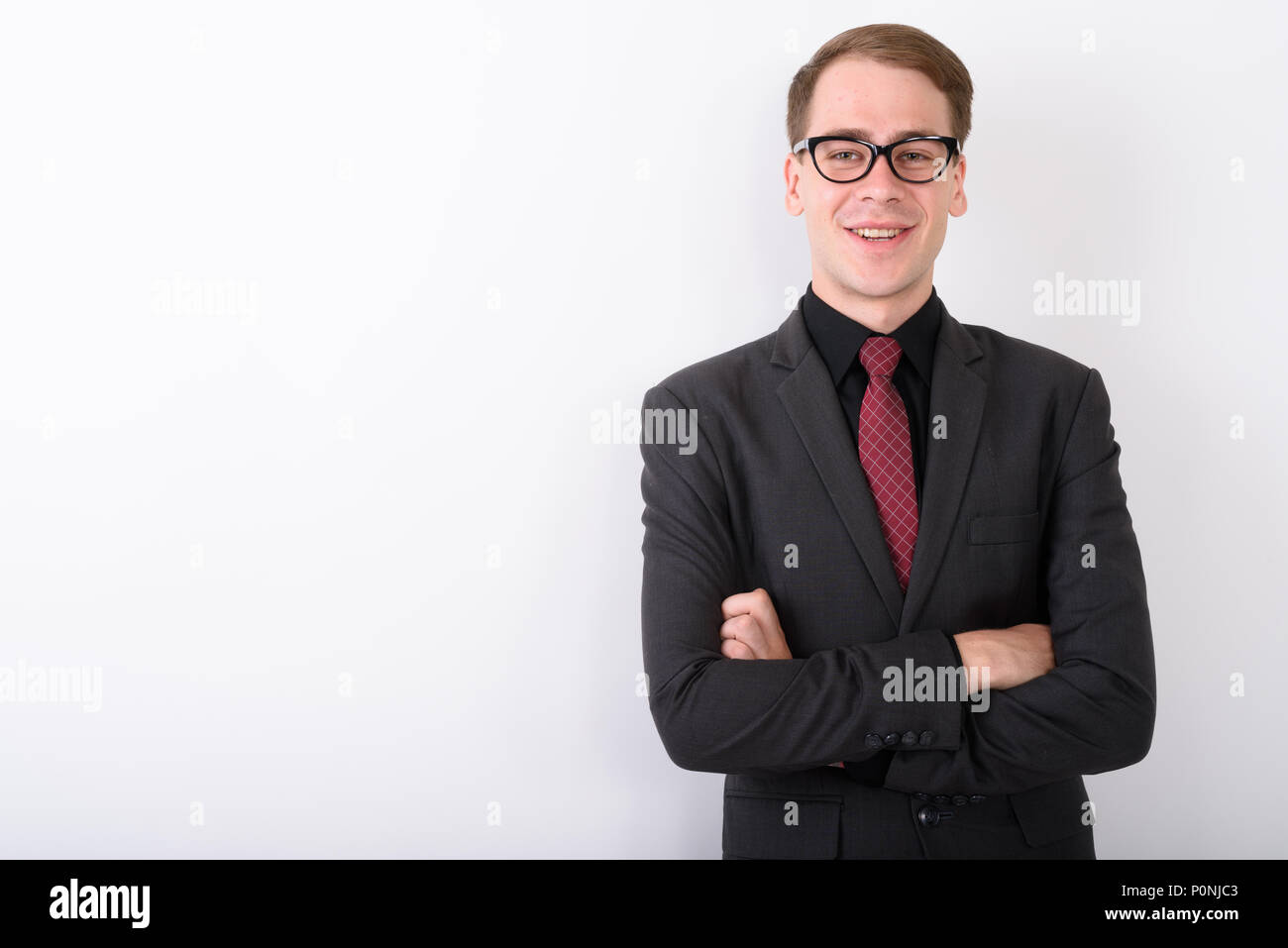 Young handsome businessman wearing suit against white background Stock ...